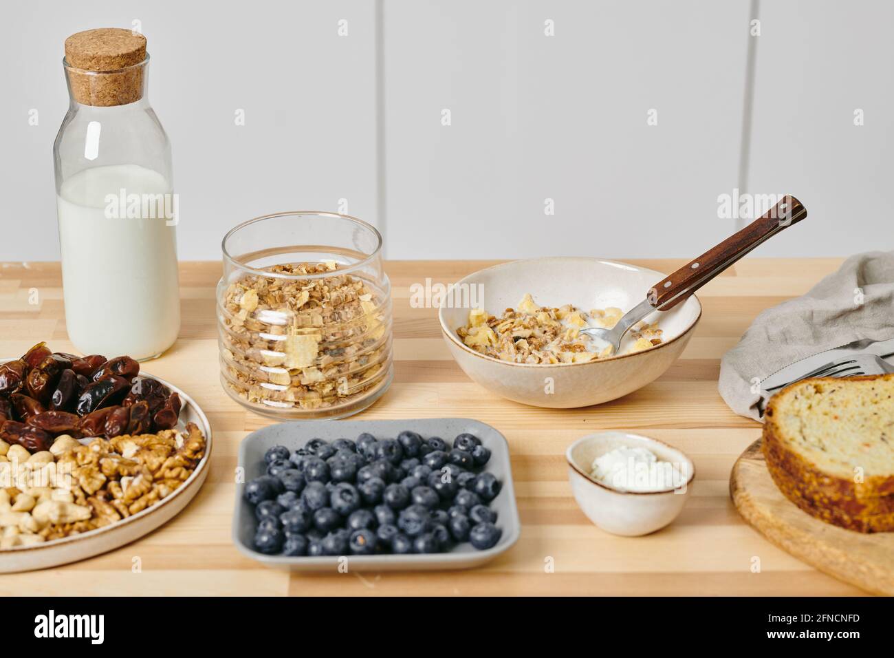 Wooden table with plates and bowls of food in the kitchen Stock Photo ...