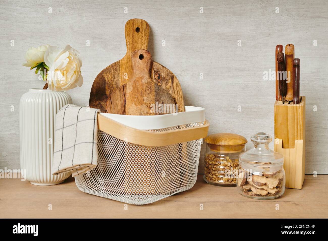 Wooden chopping boards in a white bucket and other stuff by wall Stock ...