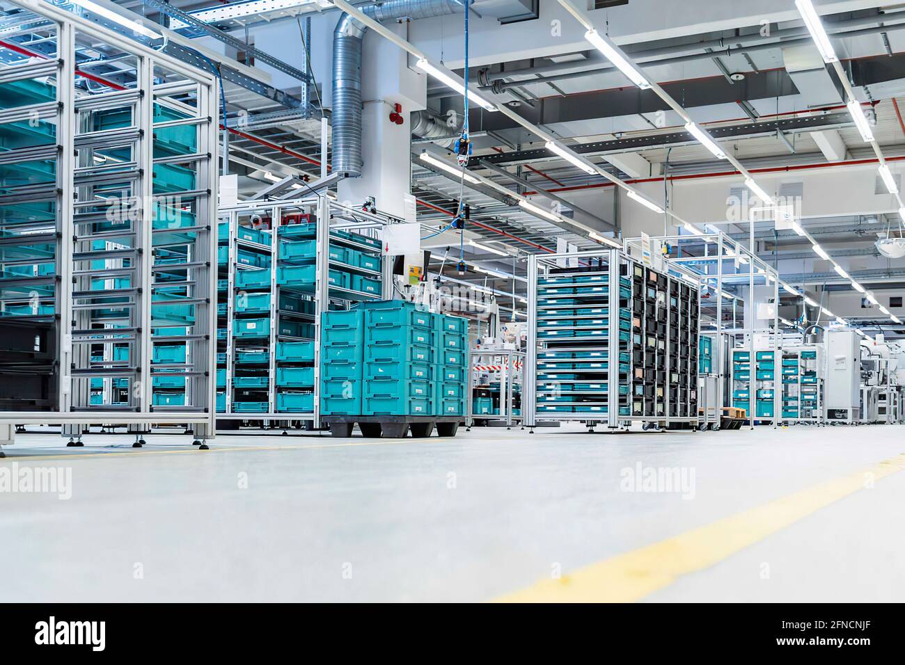 Empty warehouse interior with shelves, pallets , boxes and equipment ...