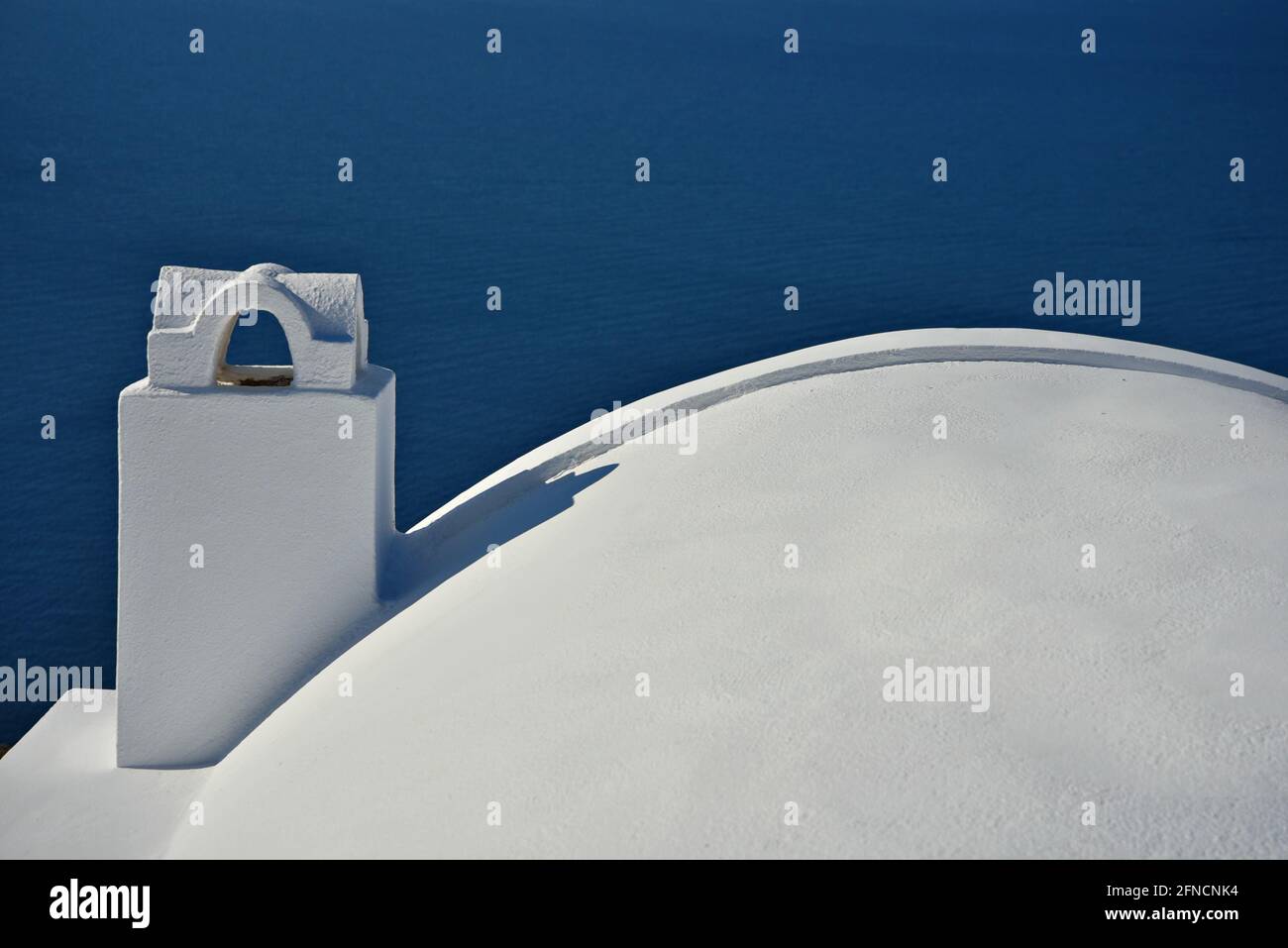 Traditional Cycladic architecture chimney on an adobe house rooftop in ...