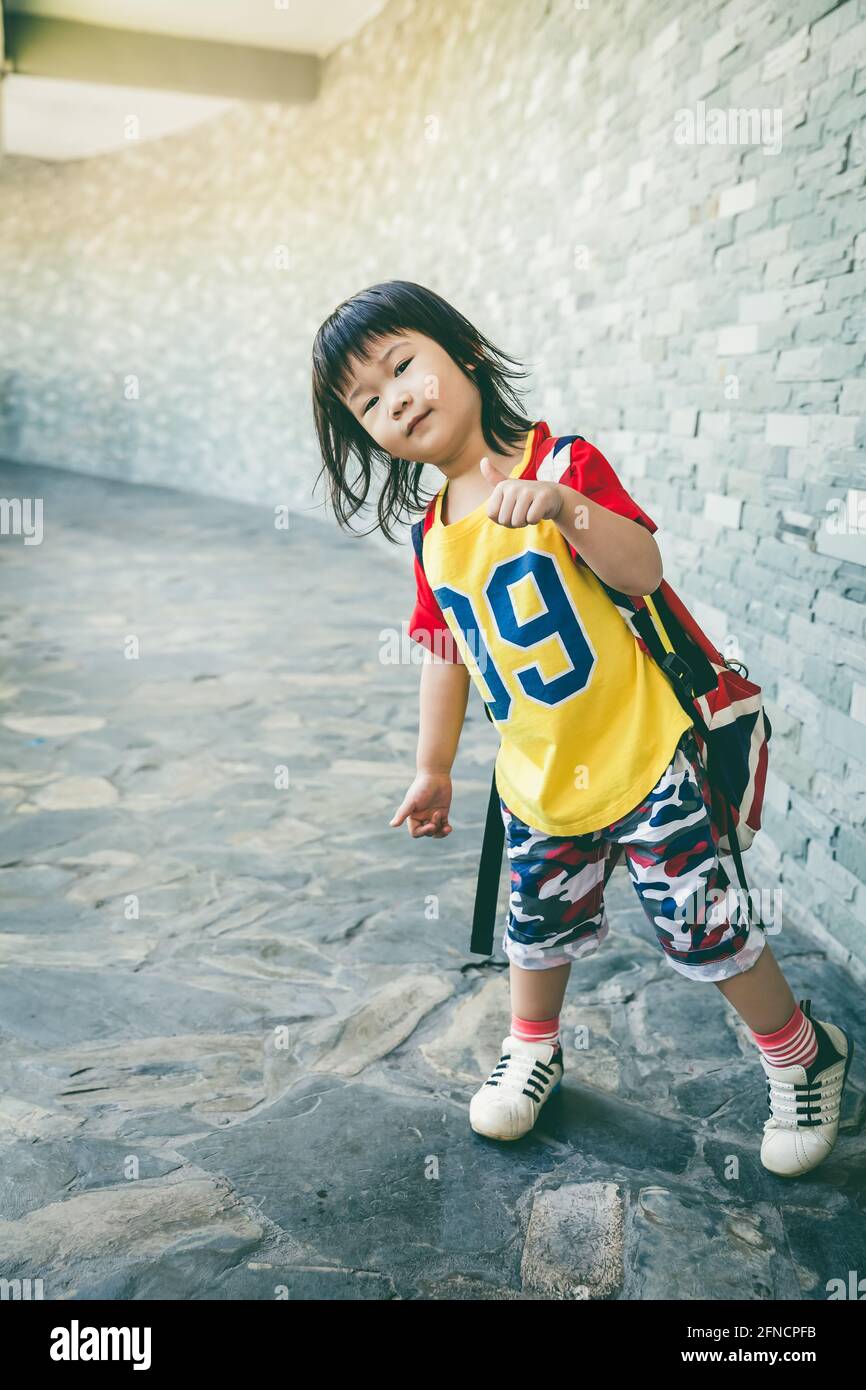 Full body of happy asian girl with thump up and looking at camera on ...