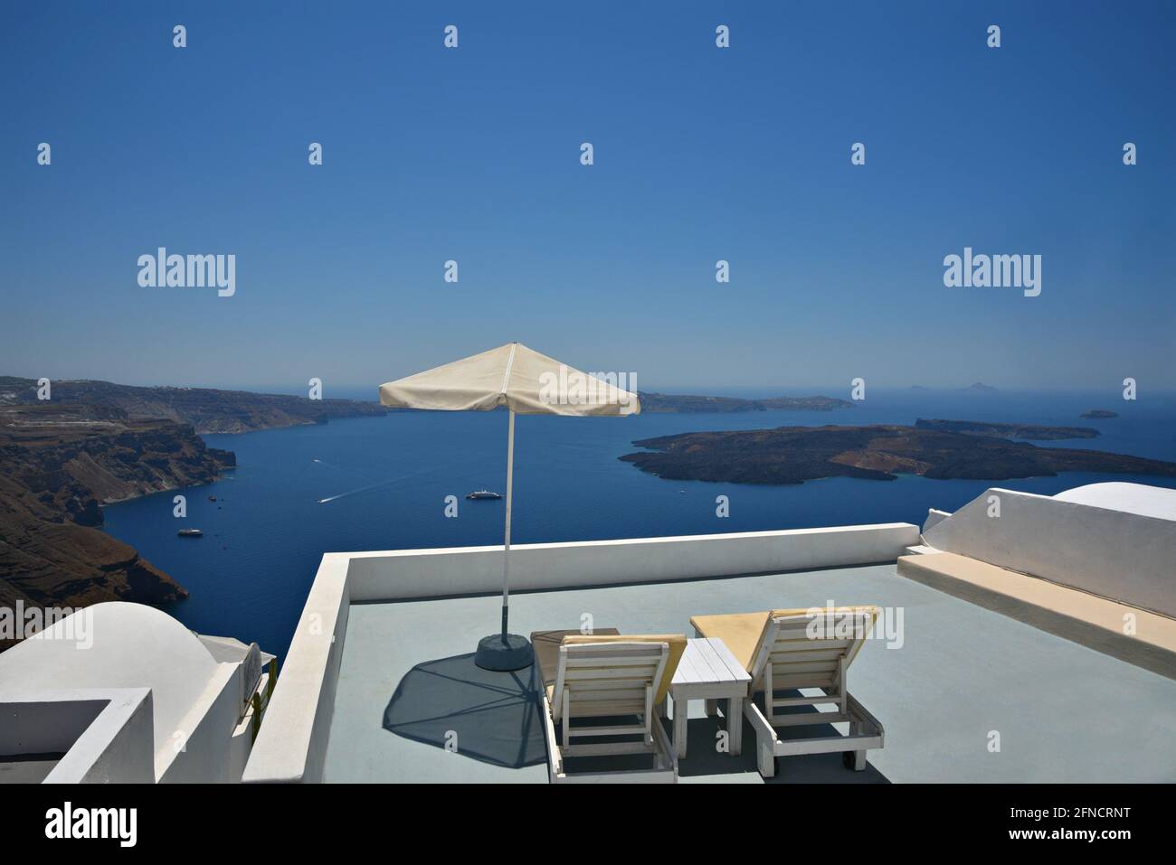 Traditional Cycladic house rooftop terrace with beach chairs and a ...