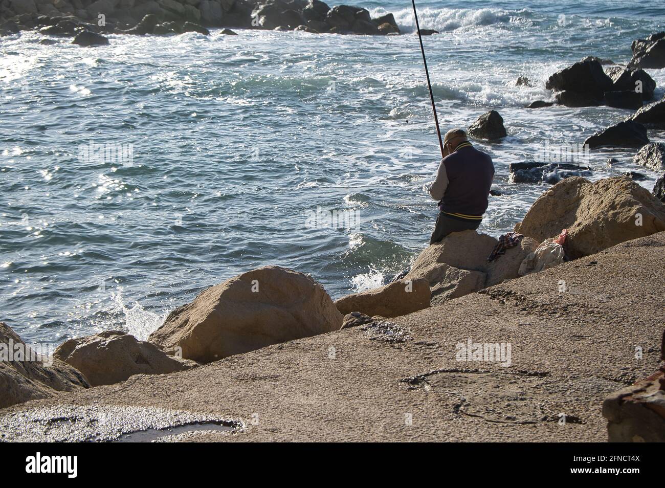 Man fishing between rocks hi-res stock photography and images - Alamy