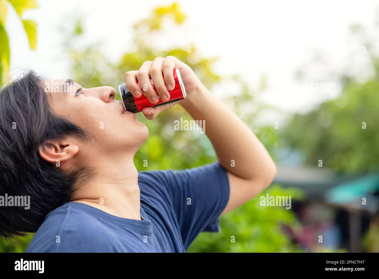 A man drinking the famous beverage Cola from can Stock Photo - Alamy