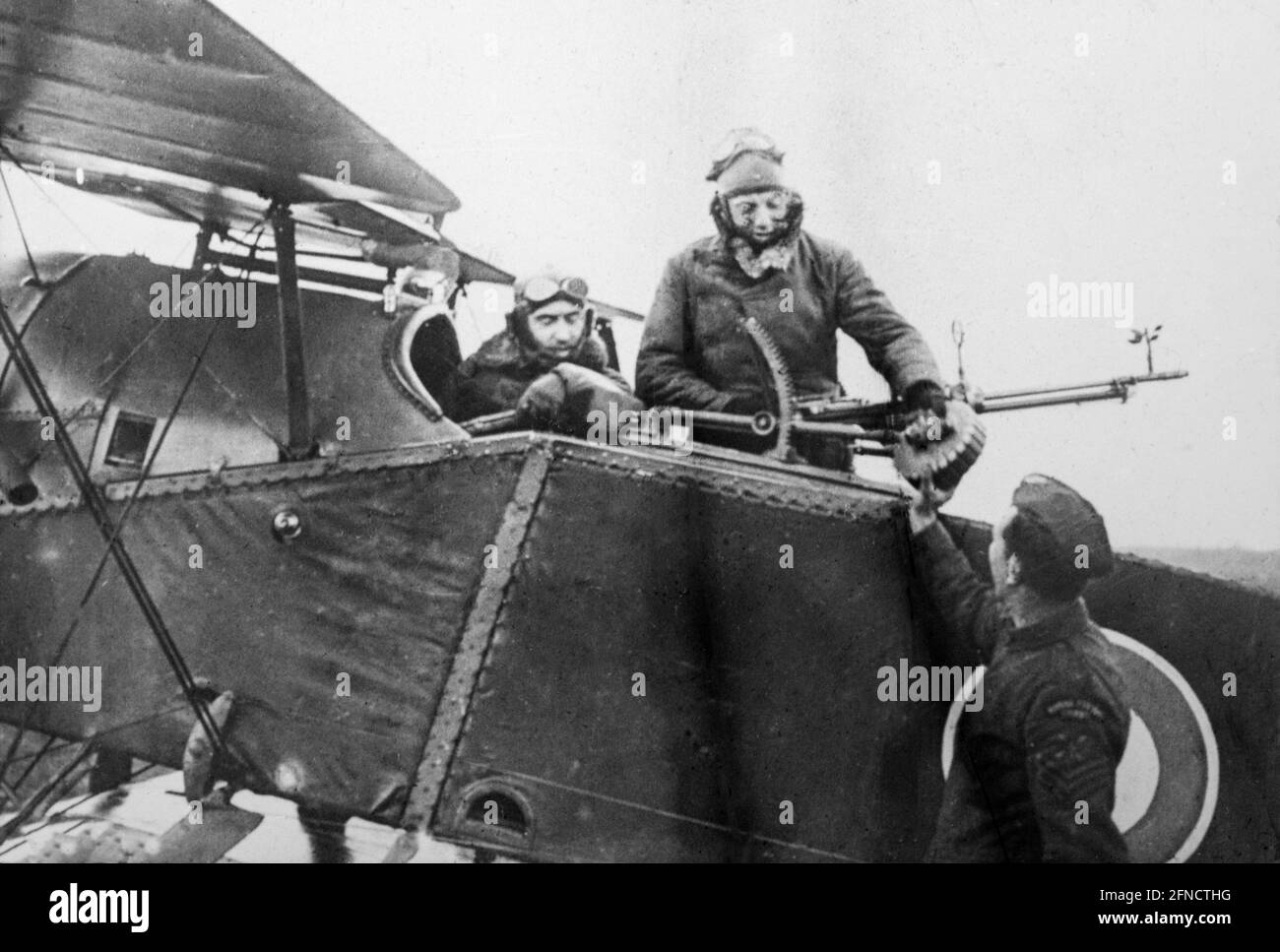 A vintage World War One black and white photograph showing two British Royal Flying Corps airman ...