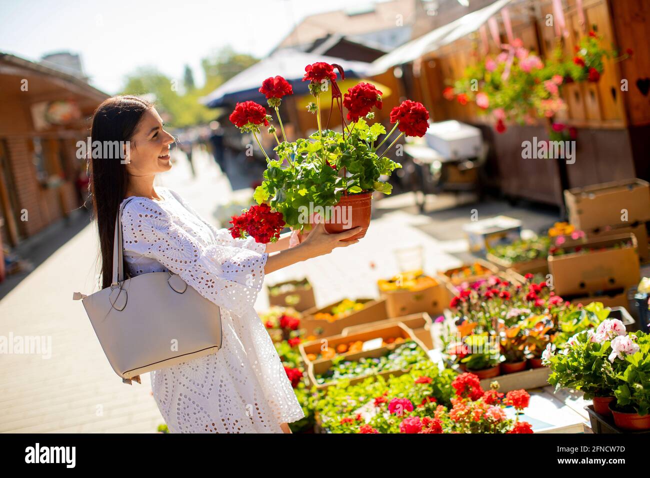 Pretty young woman buying flowers at the flower market Stock Photo - Alamy