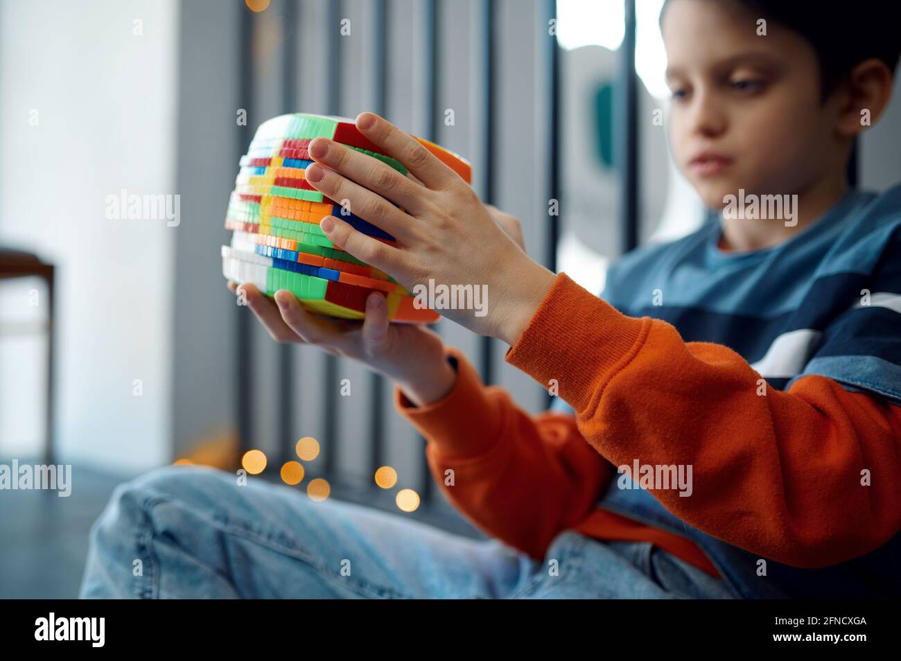 Child trying to solve difficult puzzle cube Stock Photo - Alamy