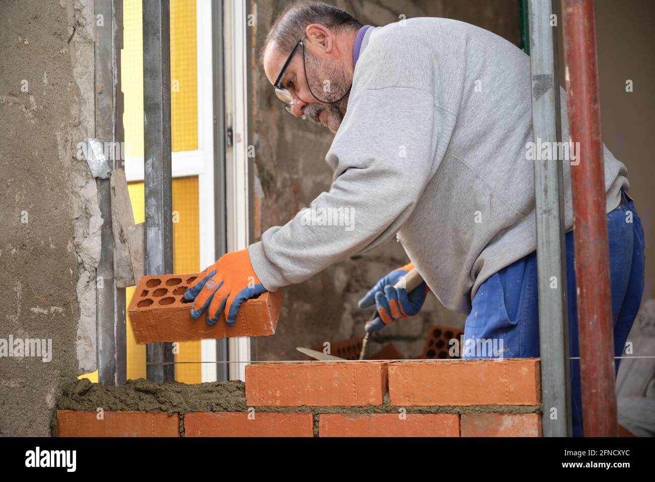 Man Building Brick Wall