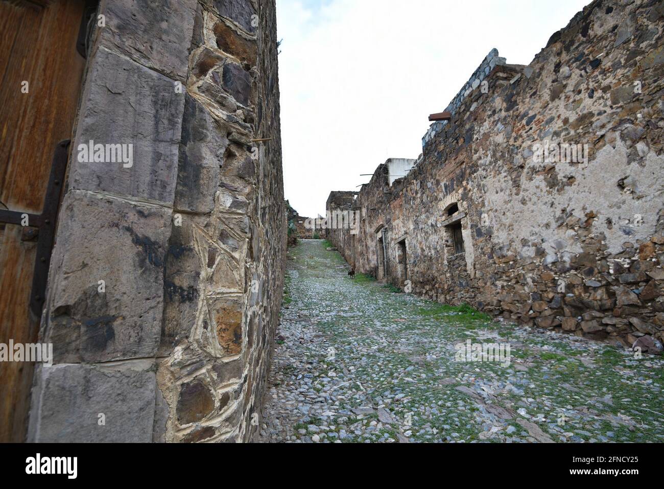 Old abandoned stone buildings on the cobblestone streets of Real de ...