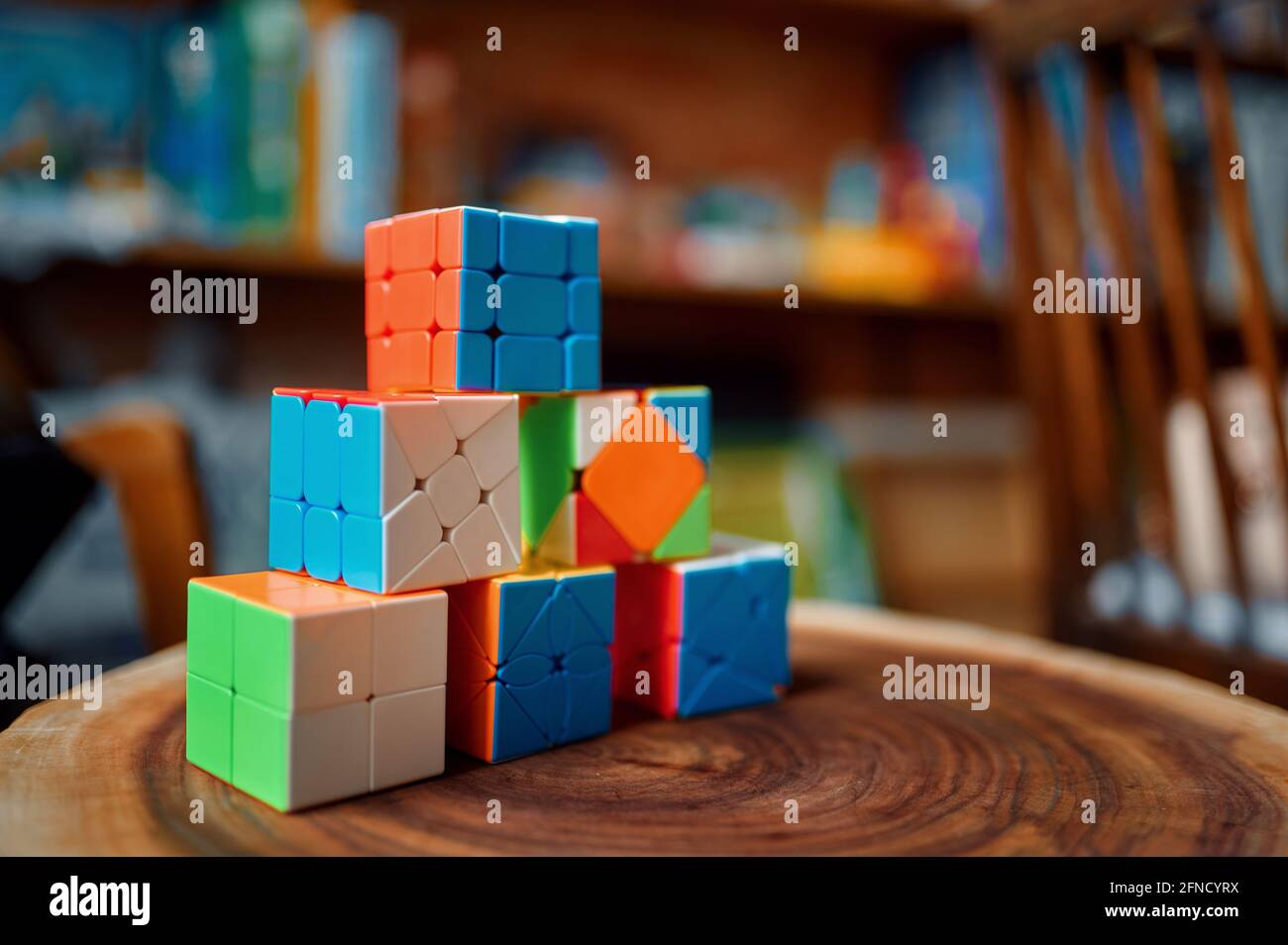 Colorful puzzle cubes on wooden stump, closeup Stock Photo - Alamy