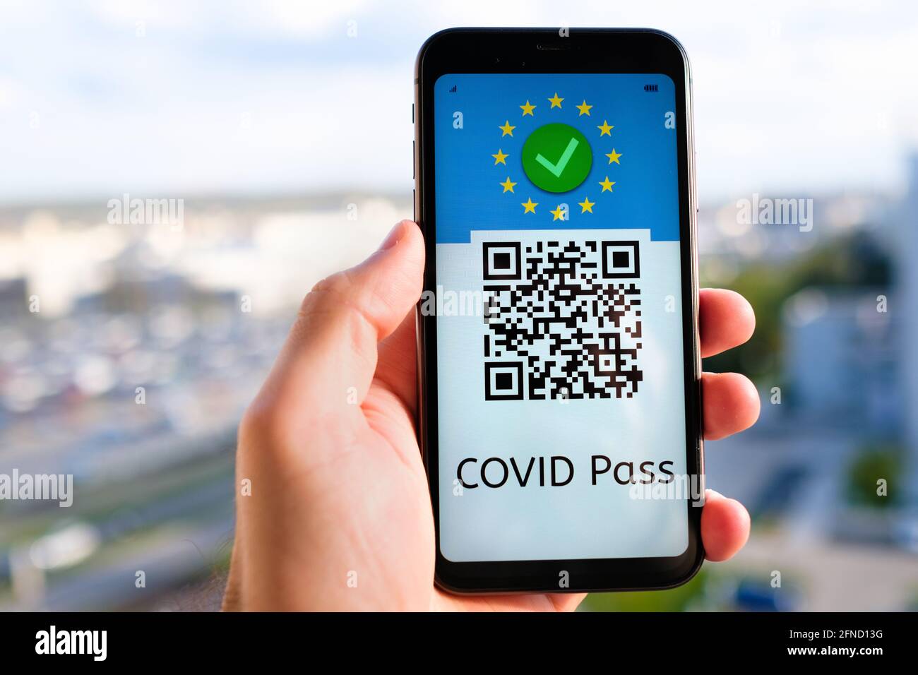 Covid pass with QR code on the screen in smartphone in mans hand on the ...