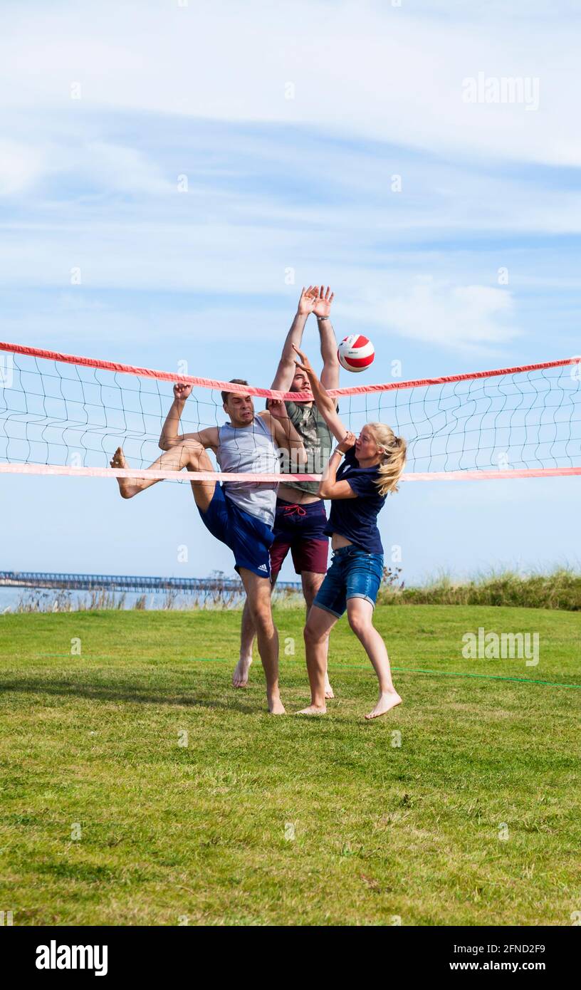 People playing Volleyball on open grassland Stock Photo - Alamy