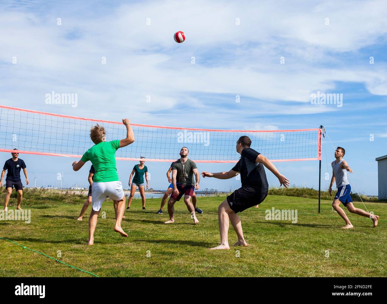 People playing Volleyball on open grassland Stock Photo - Alamy
