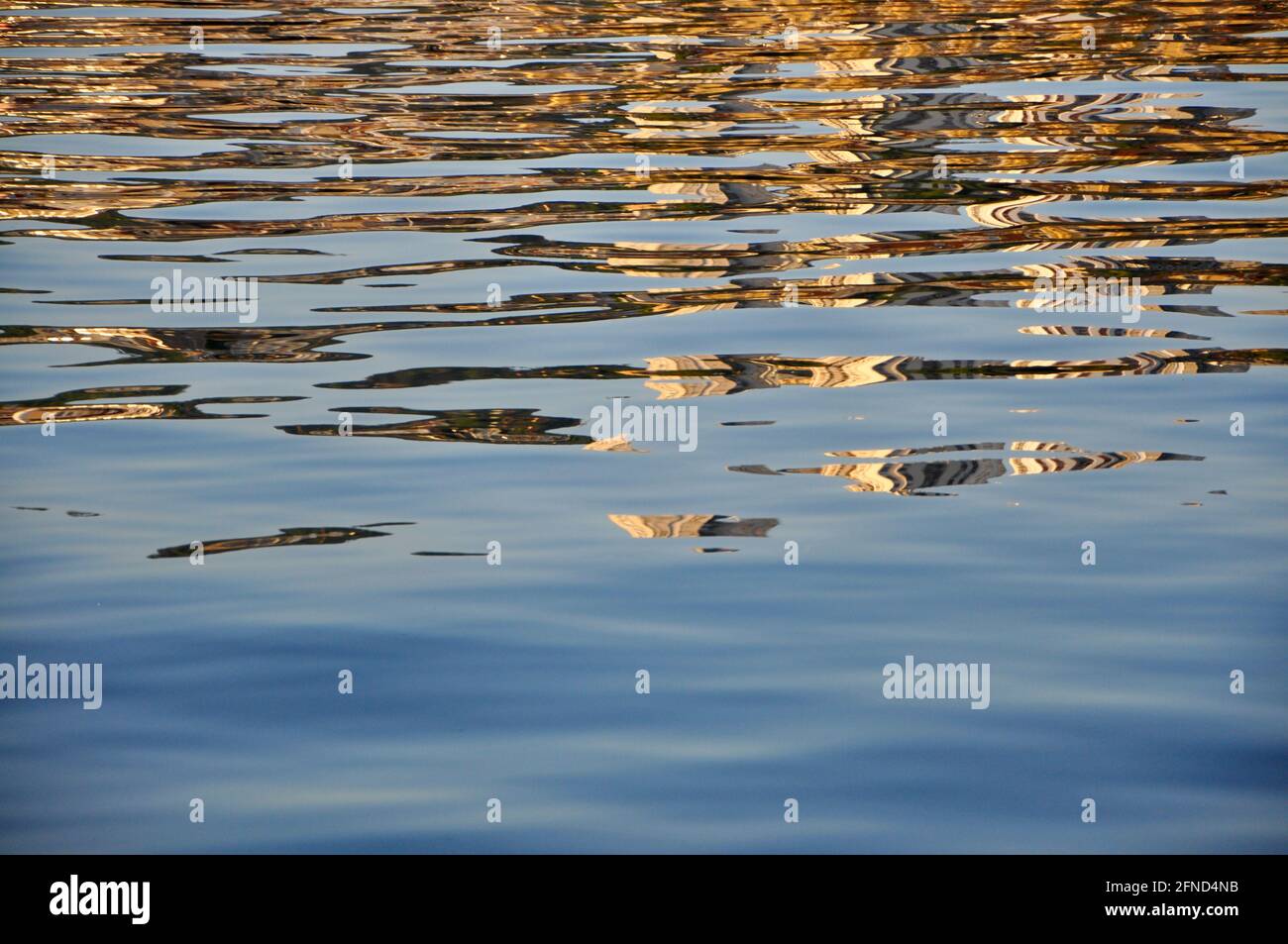 Abstract reflection of colorful Rijeka building on sea. Sea surface ...