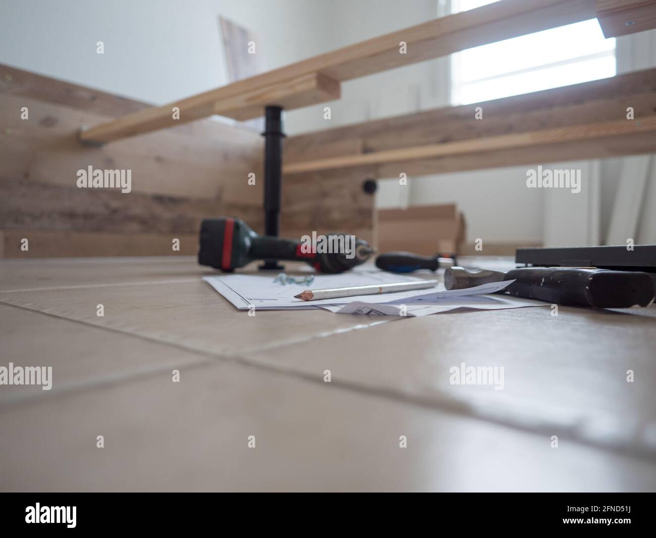 furniture - assembling the bed, lying tools and wooden elements needed ...