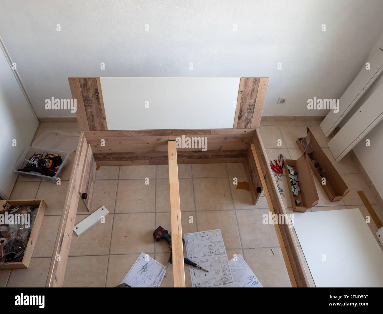 furniture - assembling the bed, lying tools and wooden elements needed ...