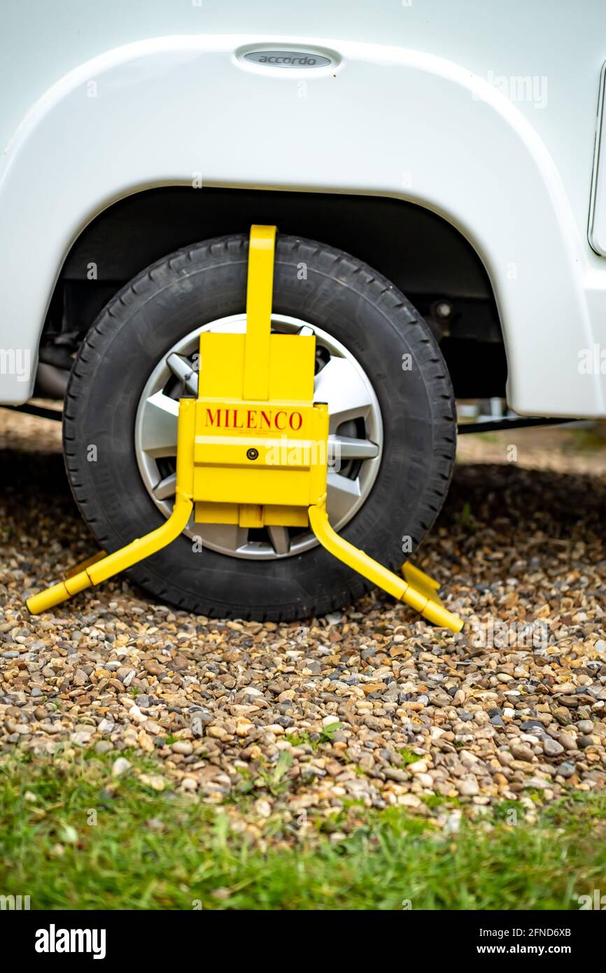 Heavy duty Milenco branded wheel clamp on the rear wheel of a coach ...