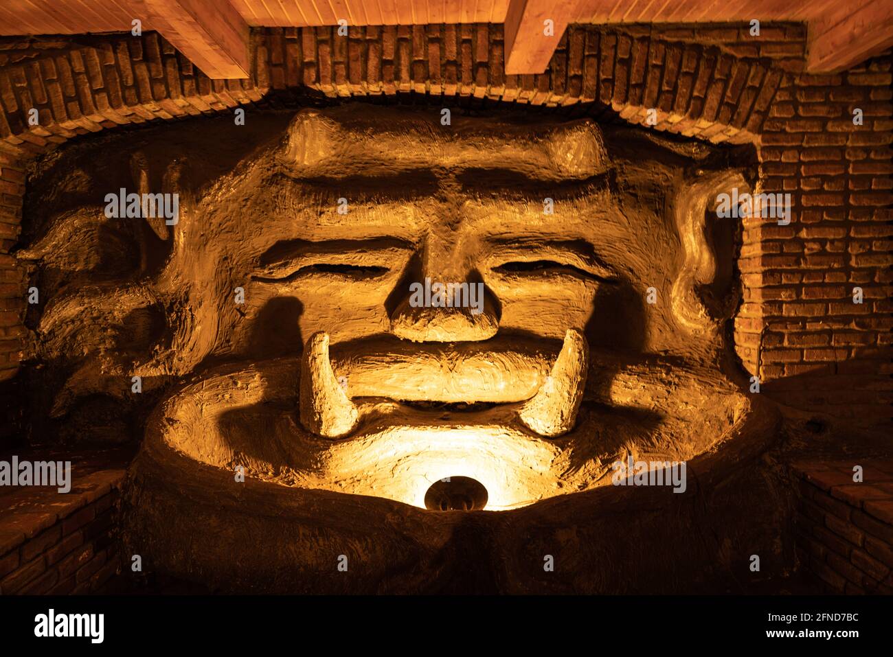 Demon face in the wine cellar Stock Photo - Alamy