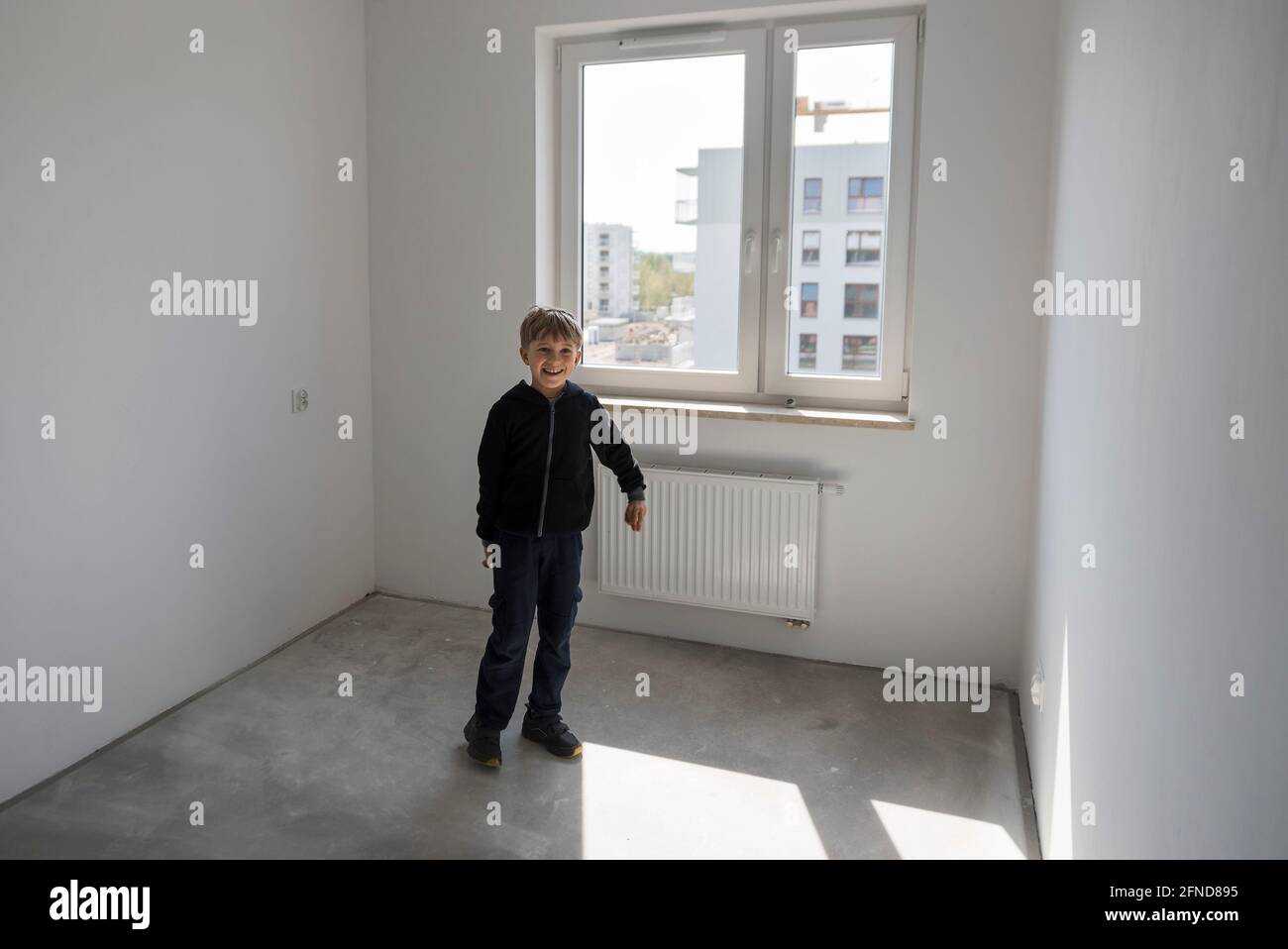 Happy young boy in his new empty room in the new flat Stock Photo - Alamy