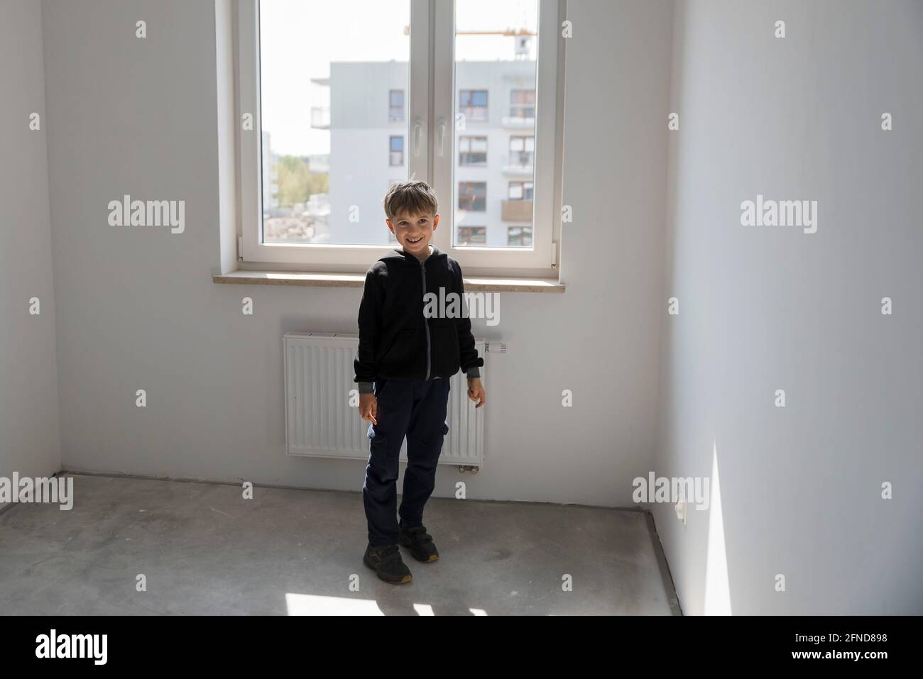 Happy young boy in his new empty room in the new flat Stock Photo - Alamy
