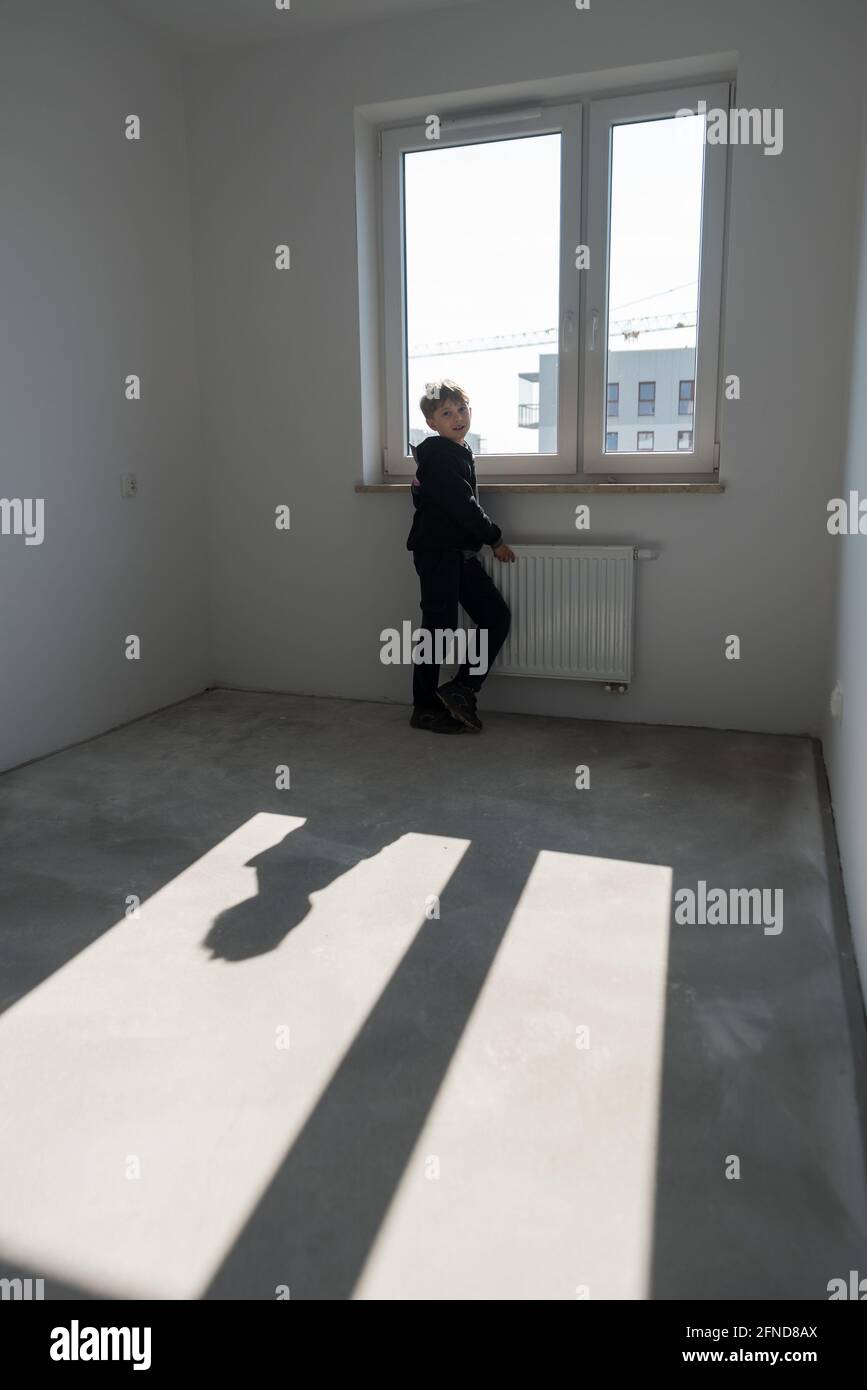 Happy young boy in his new empty room in the new flat Stock Photo - Alamy