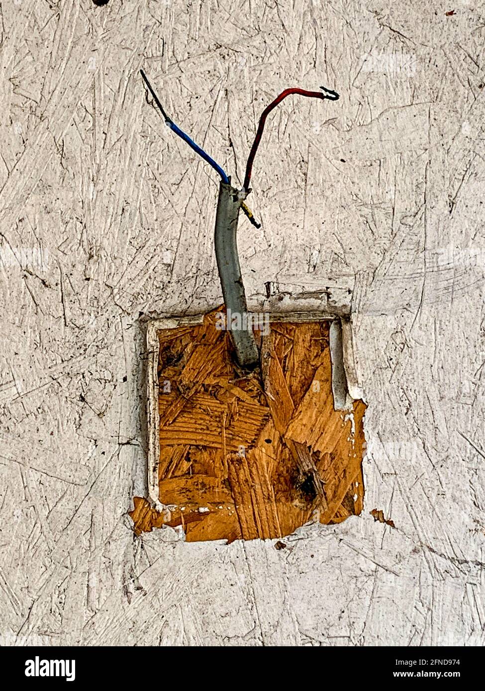 Electric cable with two bare unshielded wires poking out from boarded ...