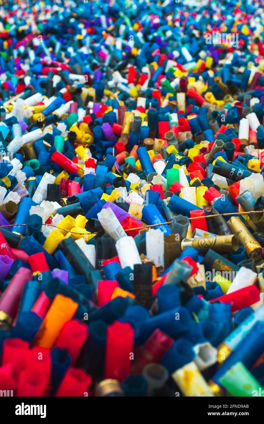 Many colorful spent shotgun shells displayed in front of a shooting ...