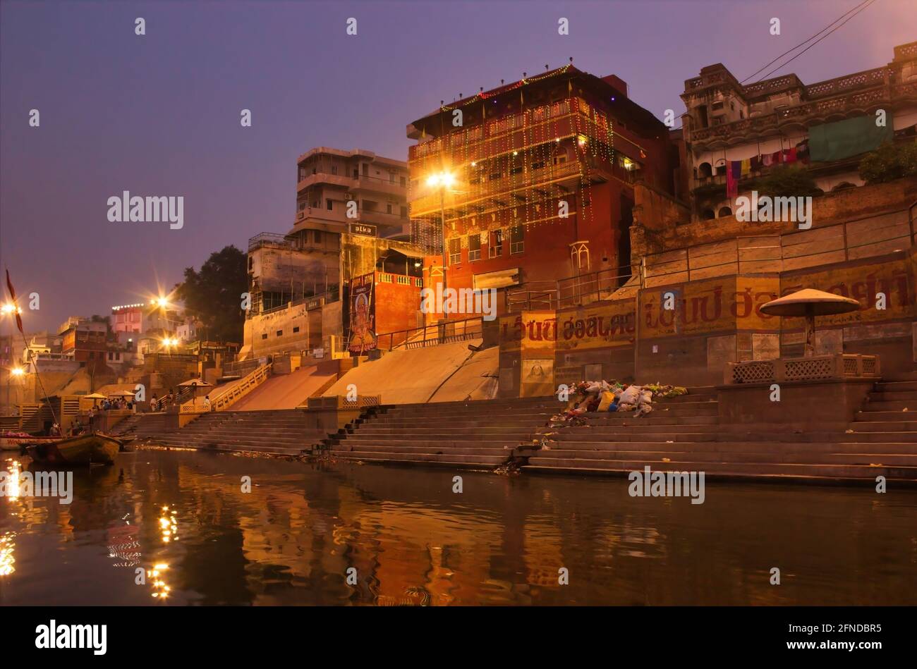 India, Varanasi Ganges river ghat with ancient city architecture as ...