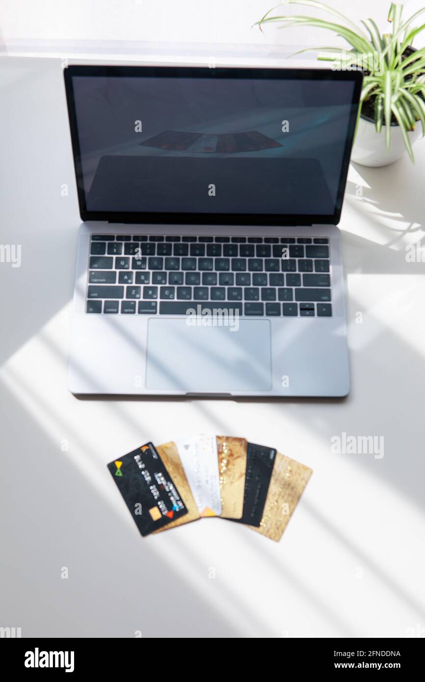 overhead top view laptop. bank credit cards around sunny day. online ...