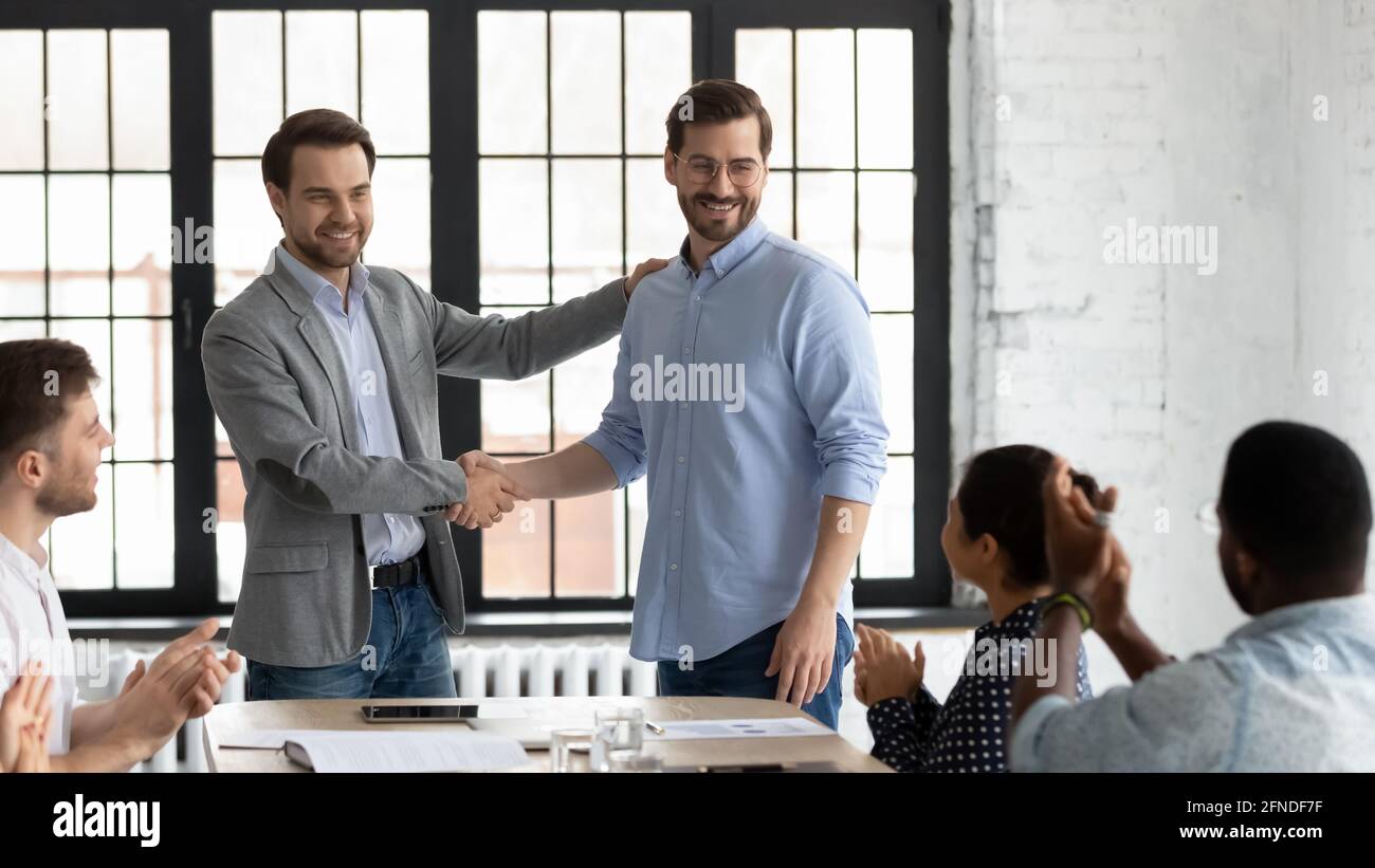 Proud boss encouraging and thanking happy employee for good job Stock ...