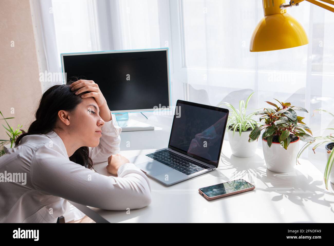 woman freelancer worker burn out laptop white screen Stock Photo - Alamy