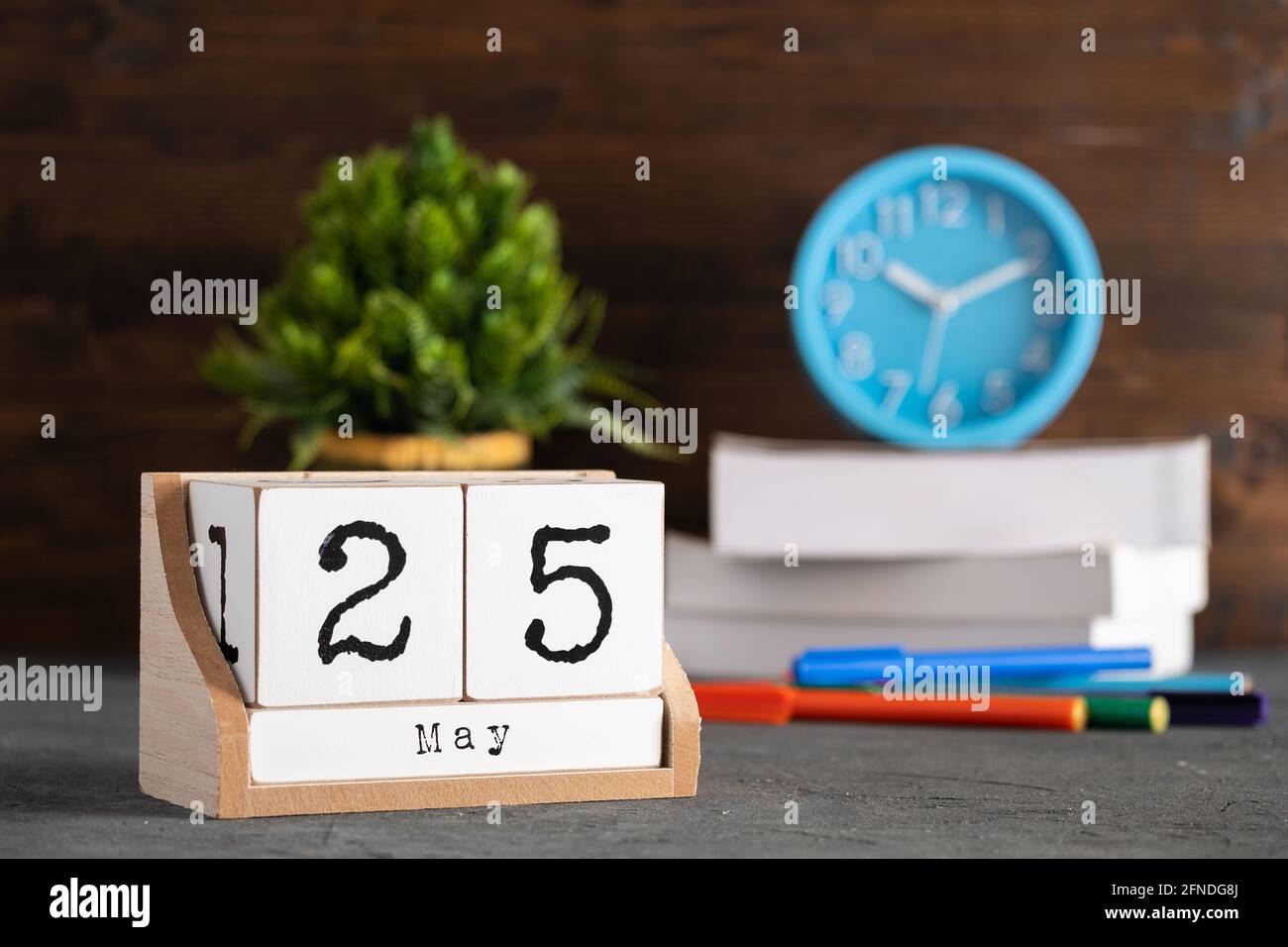 May 25th. May 25 wooden cube calendar with blur objects on background ...