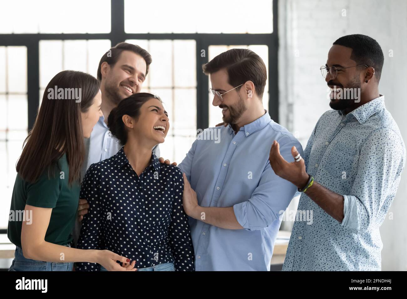 Happy coworkers congratulating excited Indian female employee Stock ...