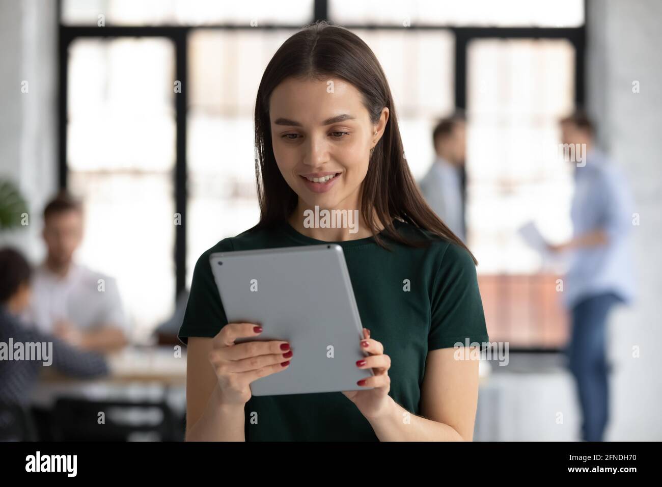 Happy female manager using tablet computer for video call Stock Photo ...