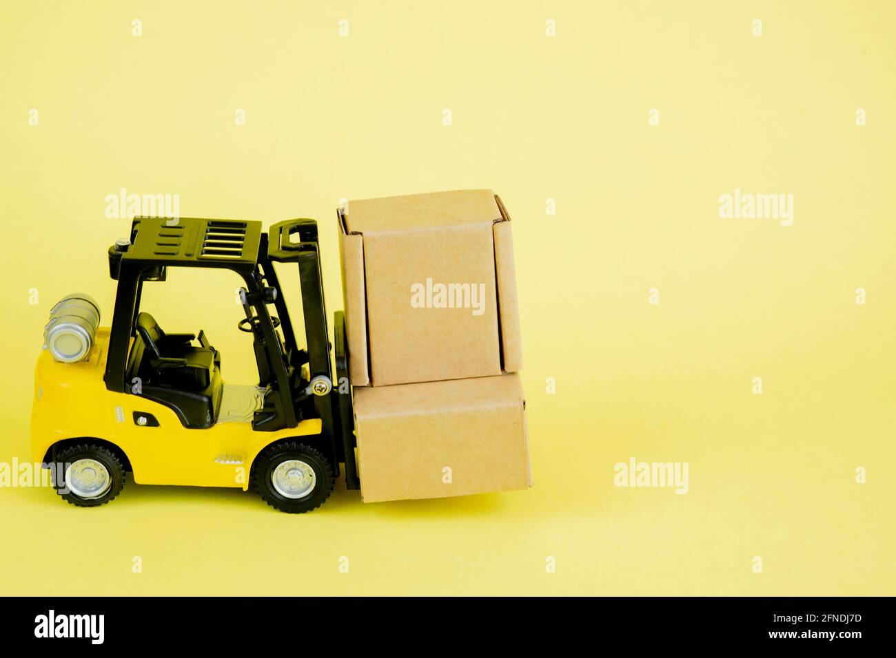 Mini forklift truck load cardboard boxes. Logistics and transportation ...