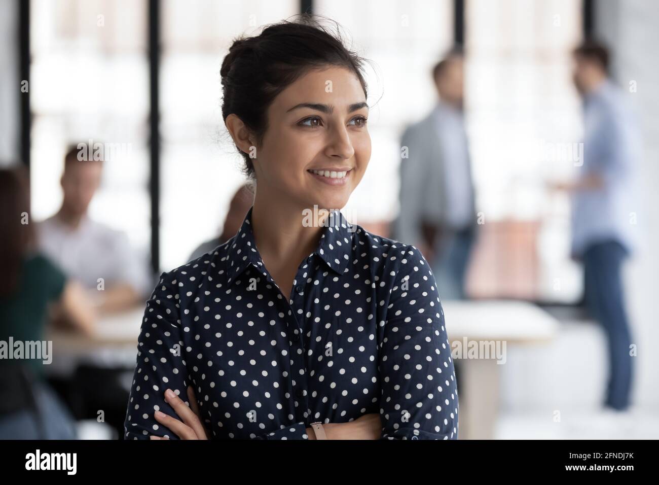 Confident smiling Indian female group leader looking at window Stock ...