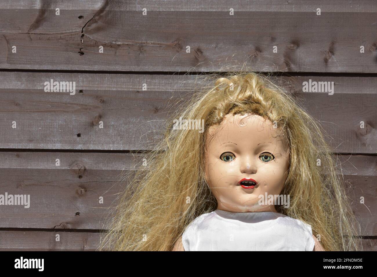 Creepy vintage doll on wooden hi-res stock photography and images - Alamy