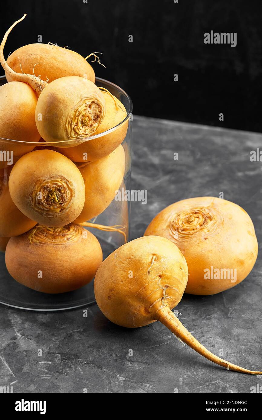 Fresh yellow turnips on a black background Stock Photo - Alamy