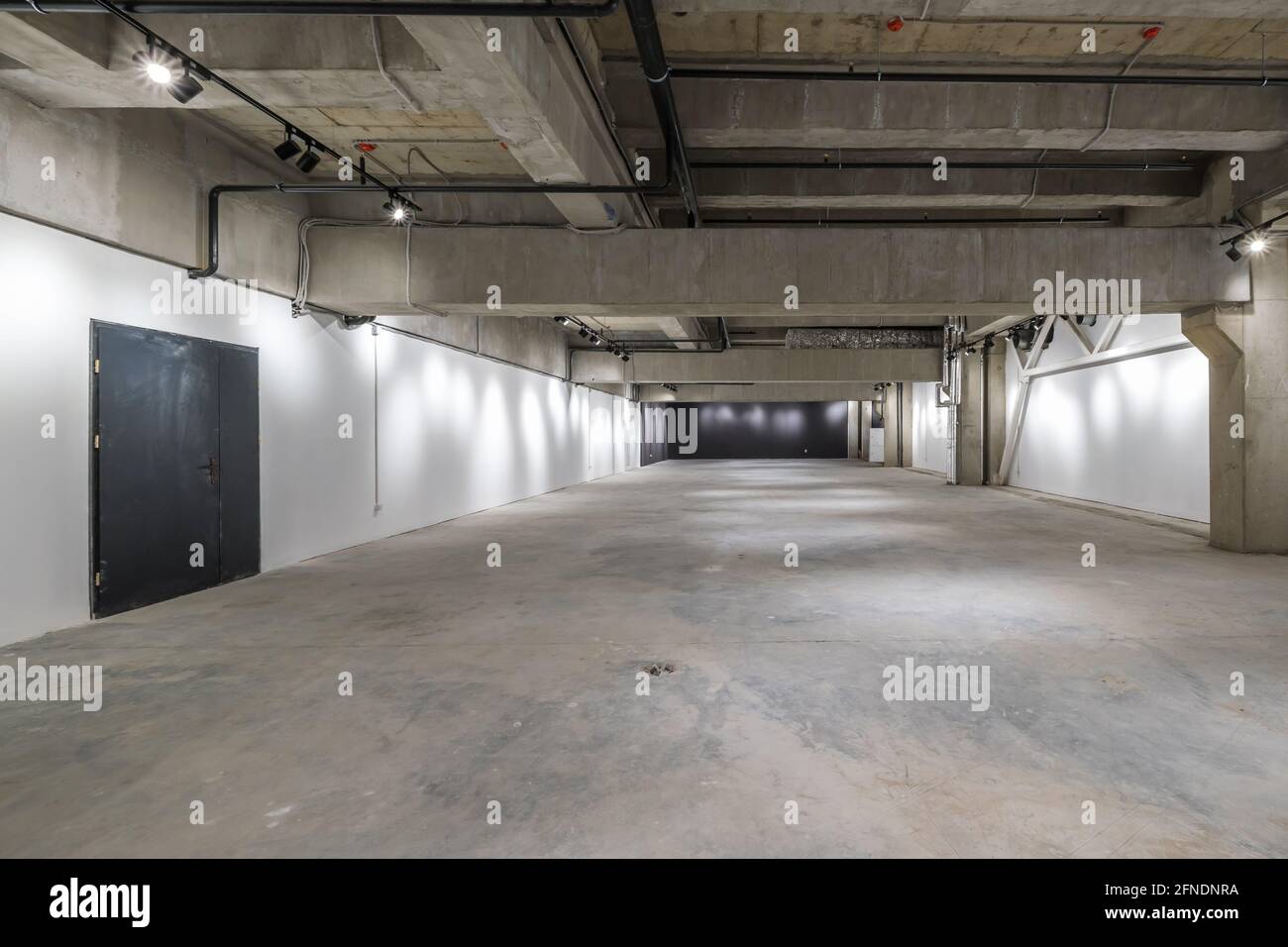 empty interior of large concrete room as warehouse or hangar with ...