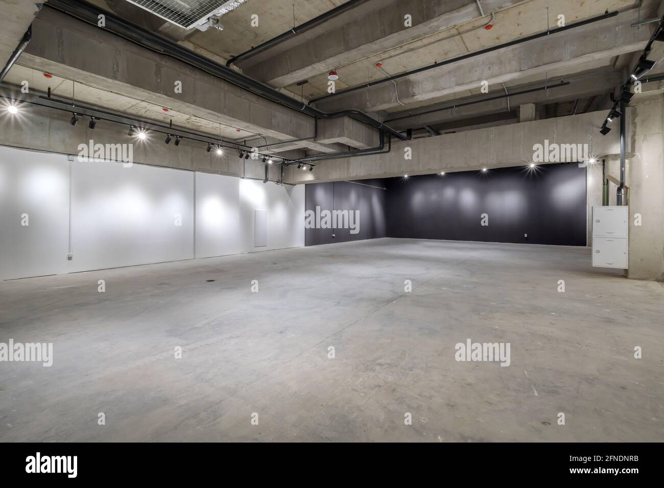 empty interior of large concrete room as warehouse or hangar with ...