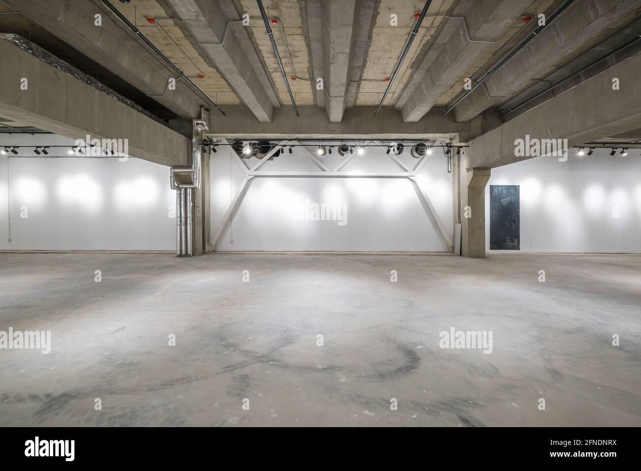 empty interior of large concrete room as warehouse or hangar with ...