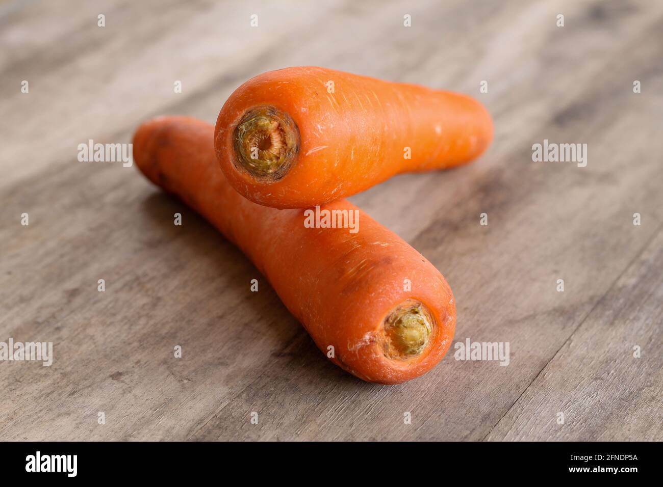 two carrots on an old wood background looks very beautiful Stock Photo ...