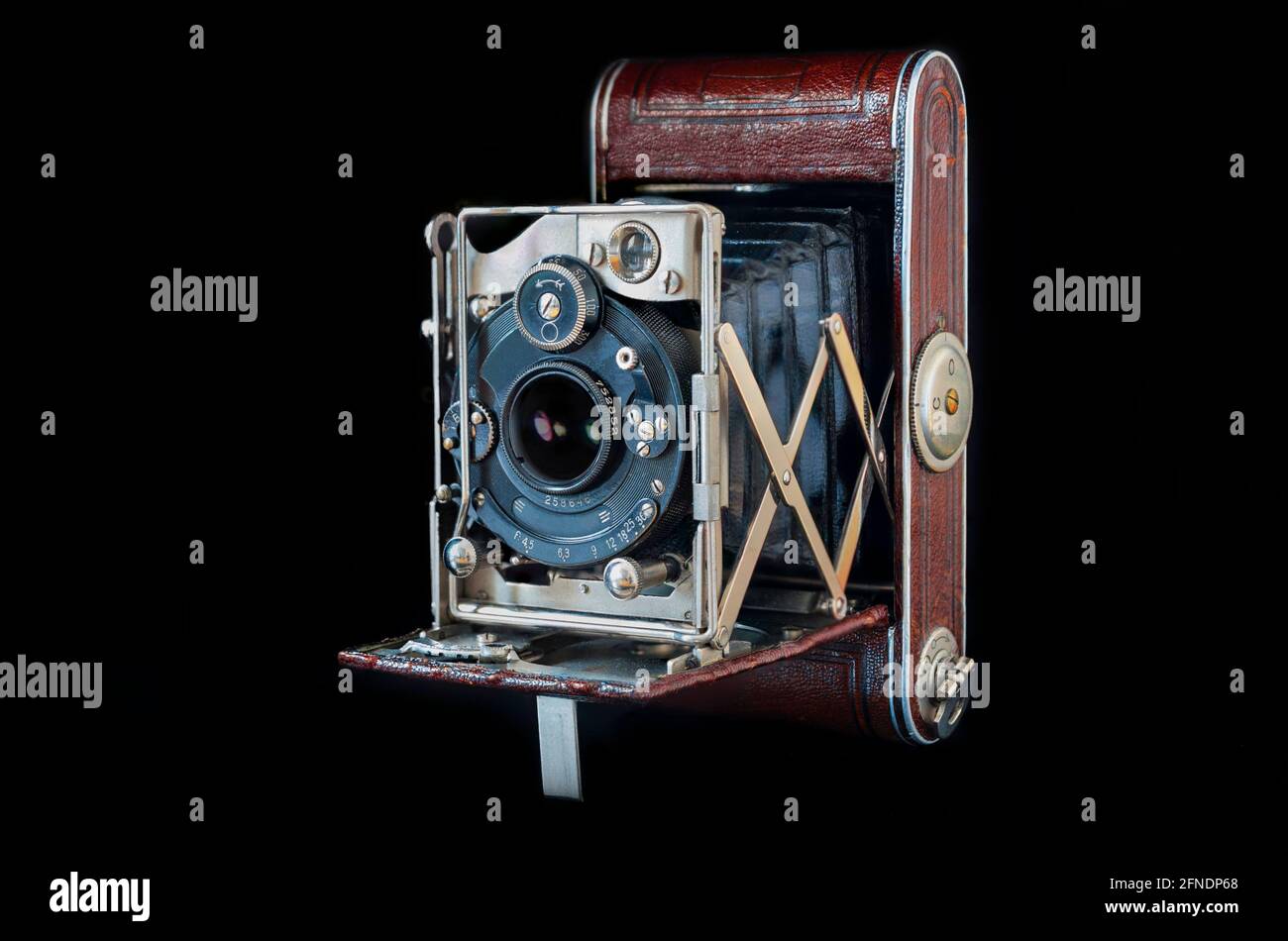 Vintage folding camera isolated on the black background. Close shoot of ...