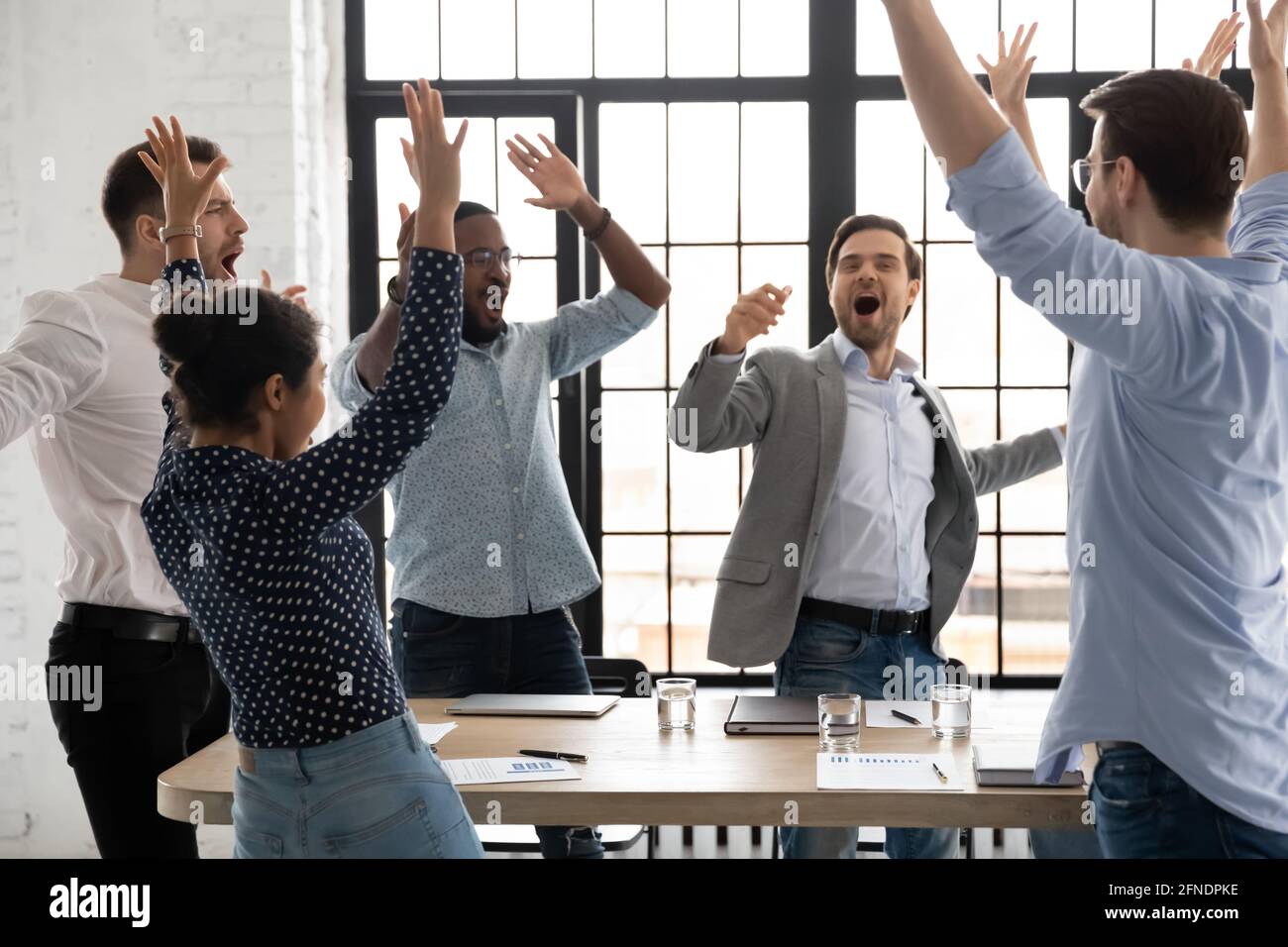 Happy excited millennial employees shouting for joy Stock Photo - Alamy