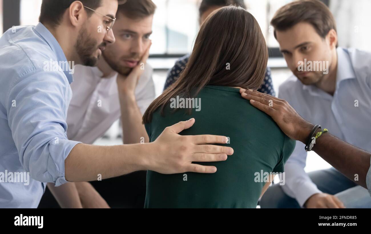 Support team consoling unhappy crying support group mate Stock Photo ...