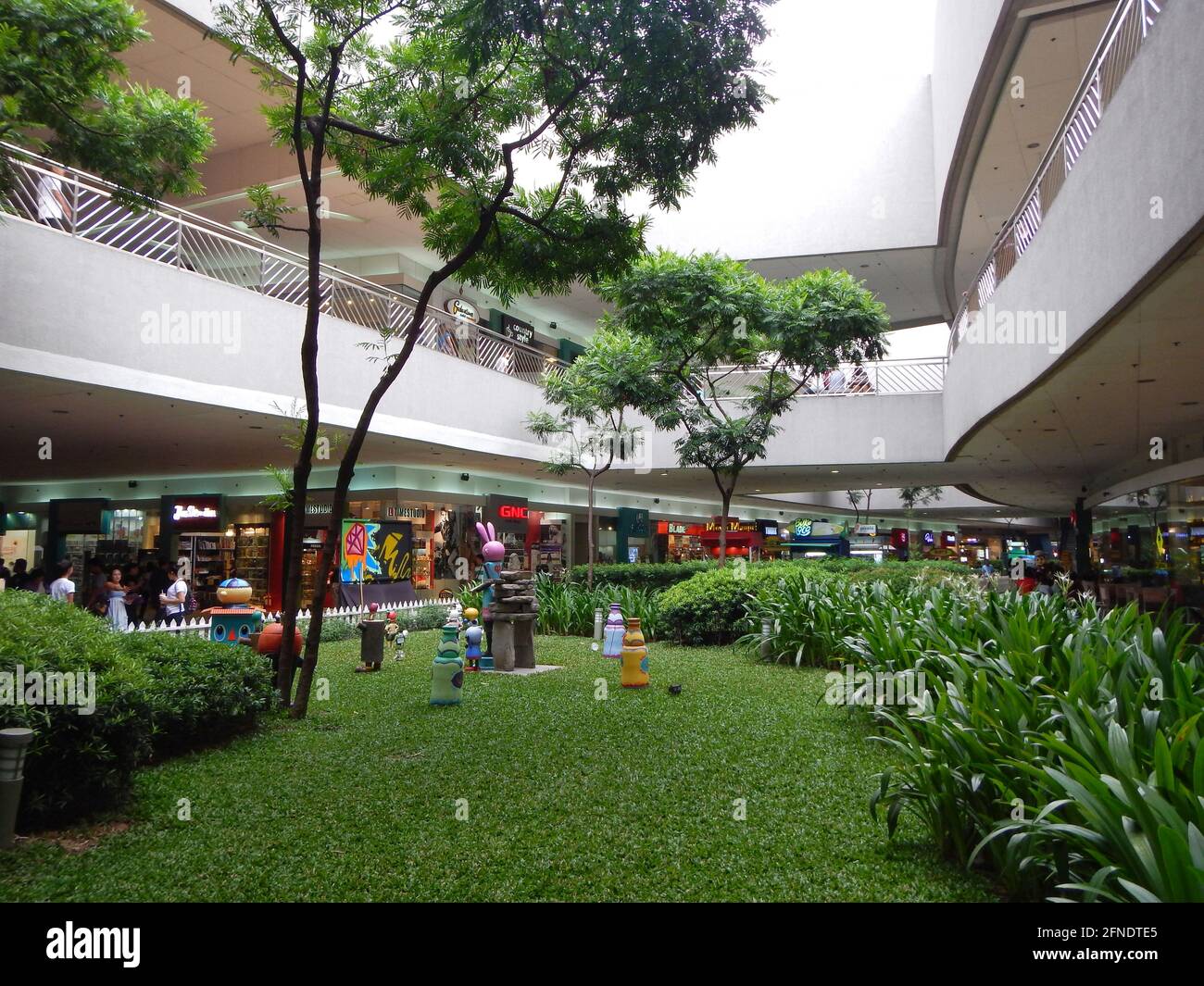 Shoppers sit and walk around Mall of Asia, Metro Manila, Philippines ...