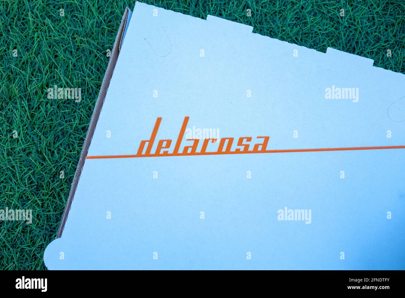 Close-up of the Delarosa Pizzeria company logo printed on a white pizza ...