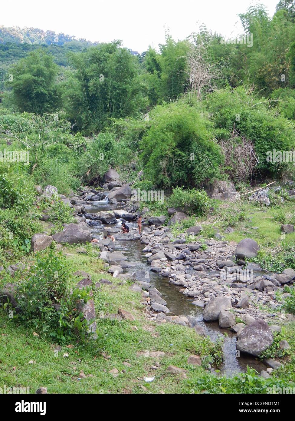 Kids refreshing themselves in a small stream near Mambukal Hot Spring ...