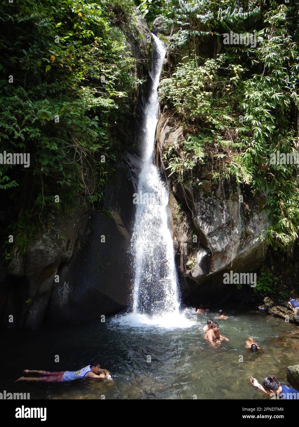 Waterfall over a lake in Mambukal Hot Spring Resort, Murcia, Negros ...