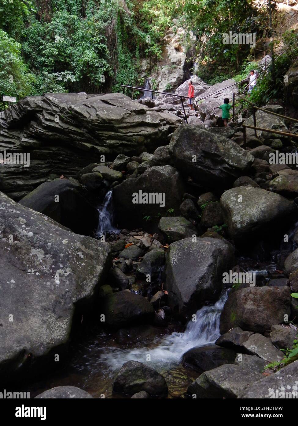 Waterfall over a lake in Mambukal Hot Spring Resort, Murcia, Negros ...
